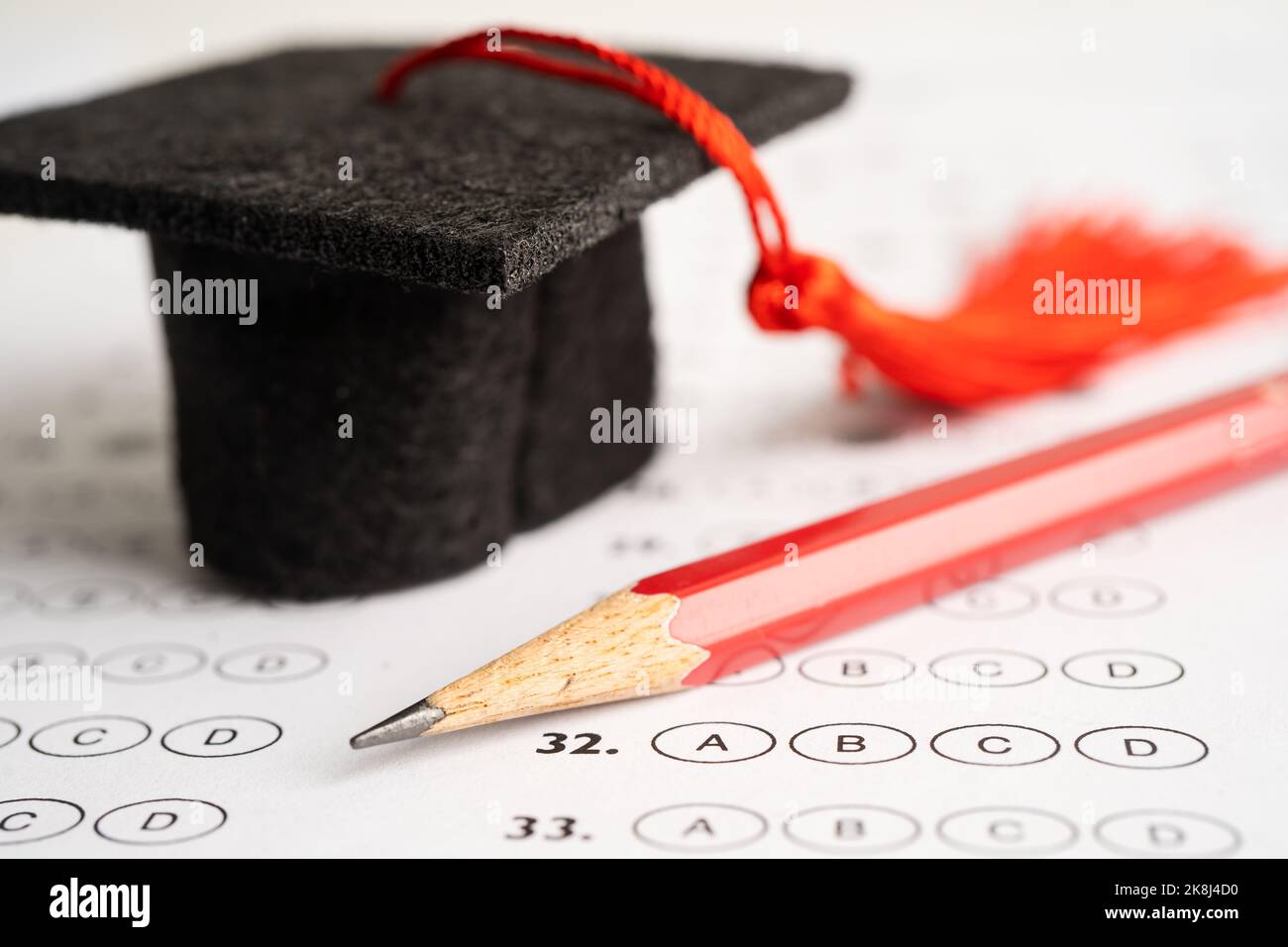 Graduation hat and pencil on Answer sheet background, Education study ...