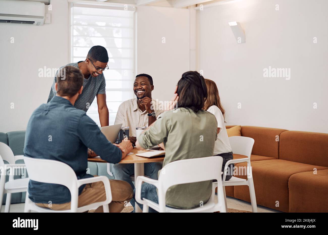 We get along so well. a diverse group of businesspeople having a ...