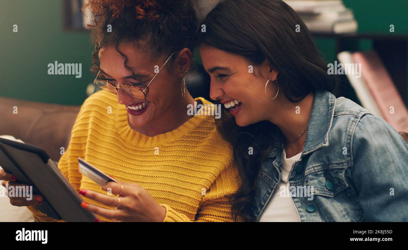 Check out the two for one special. two friends browsing online while ...