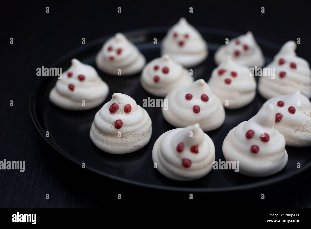 Funny meringue ghosts with funny faces, Halloween dessert Stock Photo ...