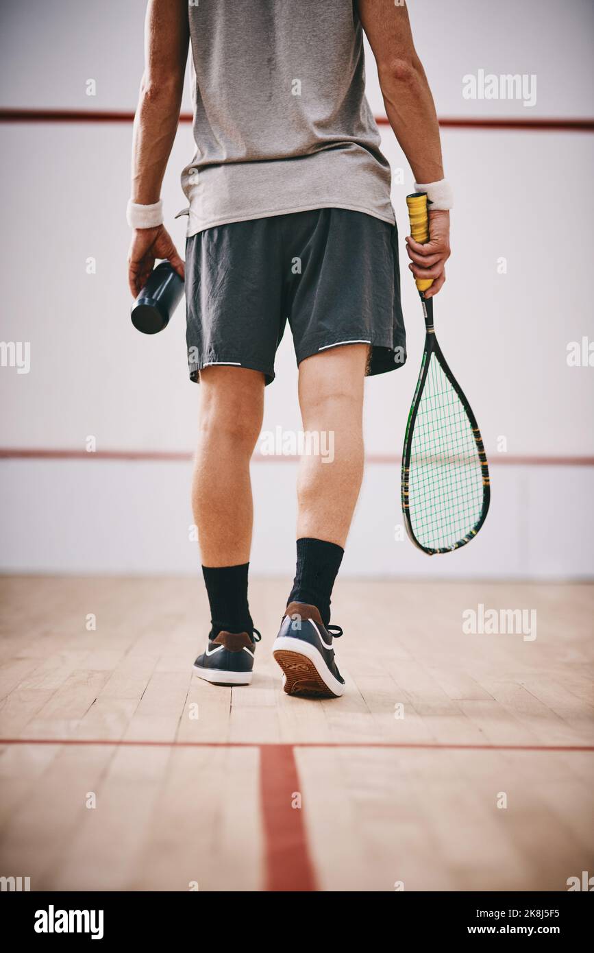In a squash league of his own. an unrecognisable man playing a game of ...