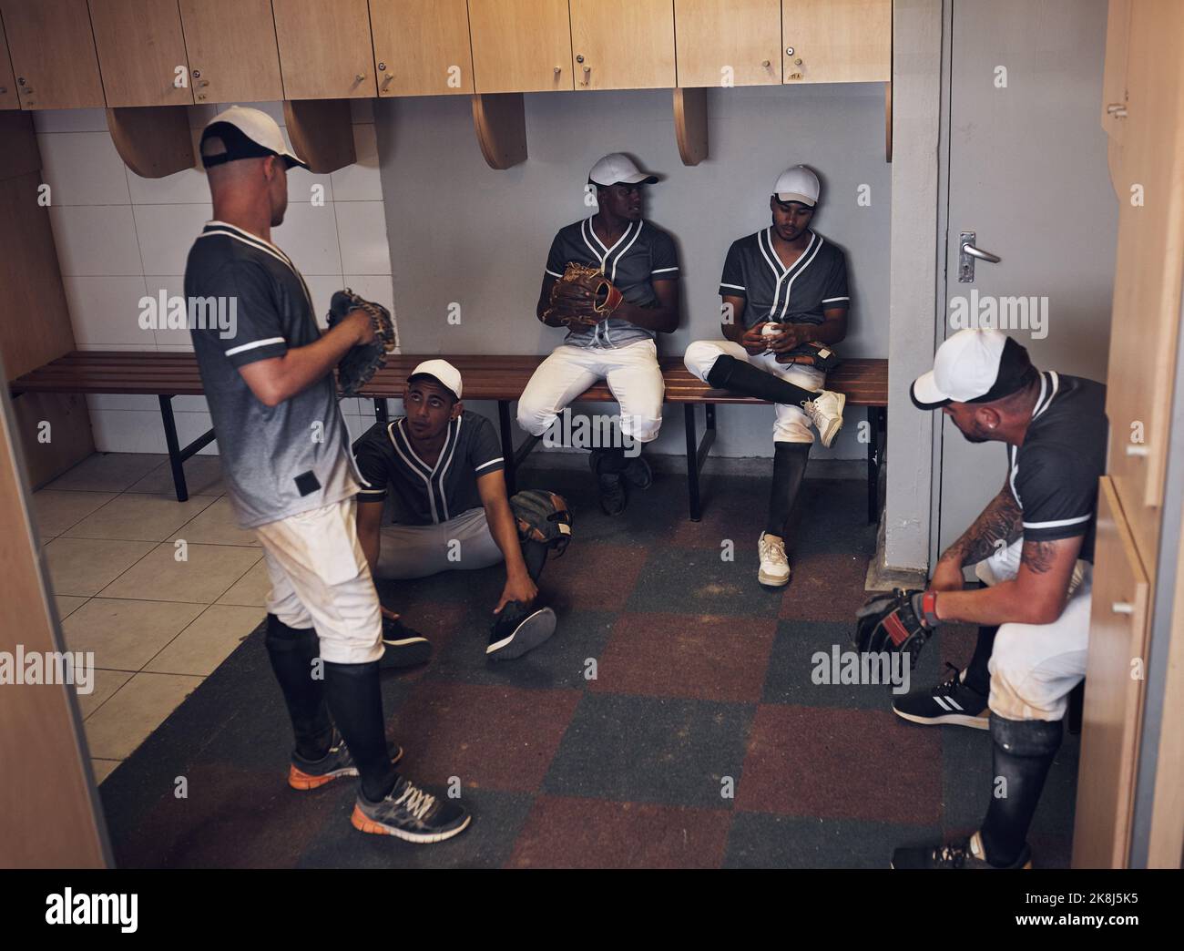Meanwhile in the locker room. a group of young men gathered in a locker ...