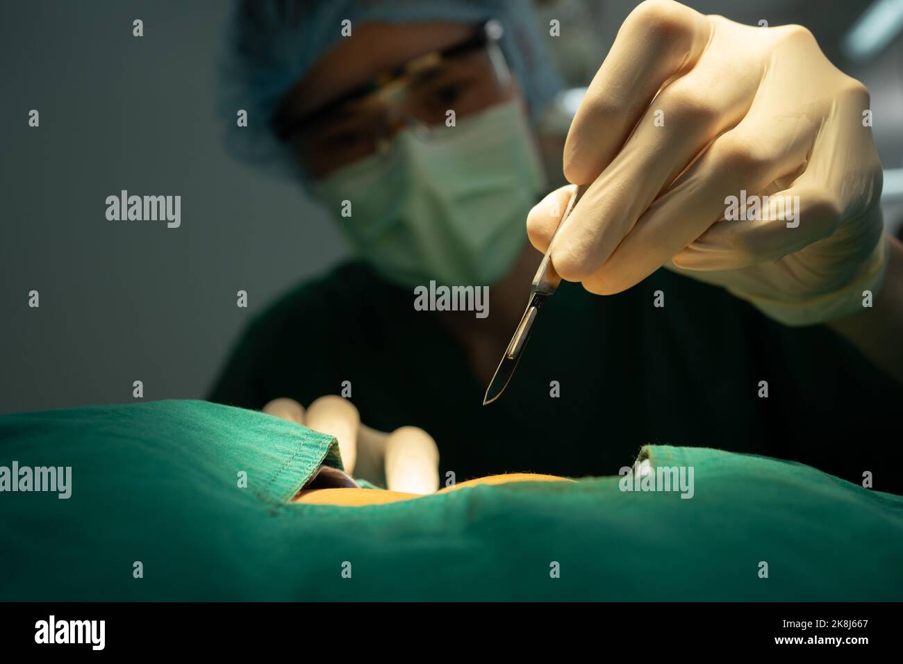 Asian Professional surgeons team performing surgery in the operating ...
