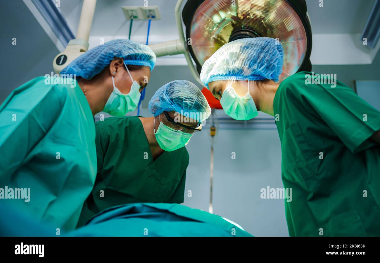 Low Angle Shot of Professional surgeons team performing surgery in ...