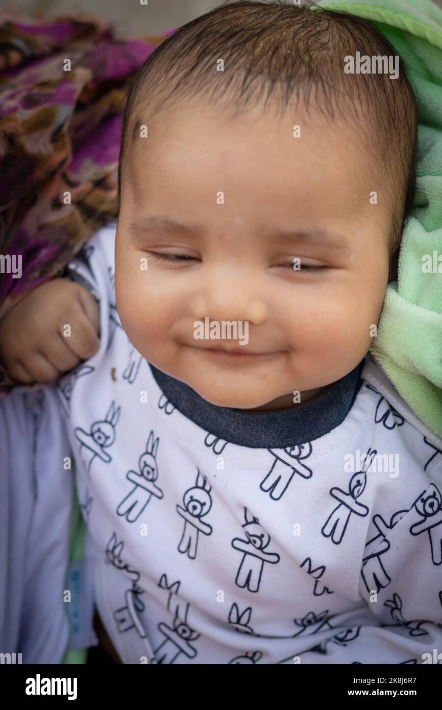 cute infant facial expression resting from top angle Stock Photo - Alamy