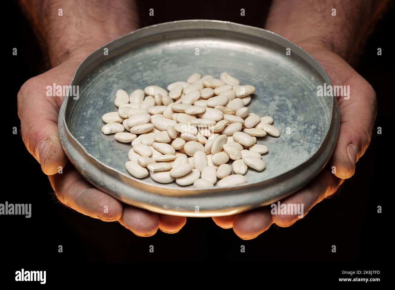 Male hands holding grains of dry kidney beans on dark background Stock ...