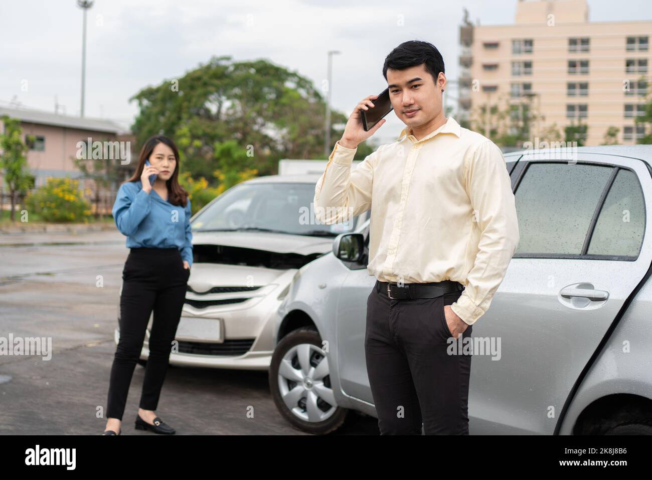 Two drivers call insurance after a car accident before taking pictures ...