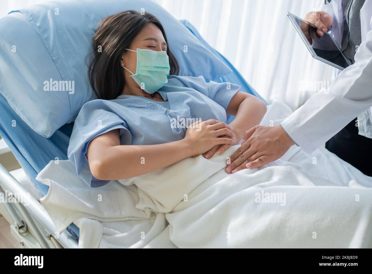 Group of Doctor try to help patient woman lie on hospital bed and ...