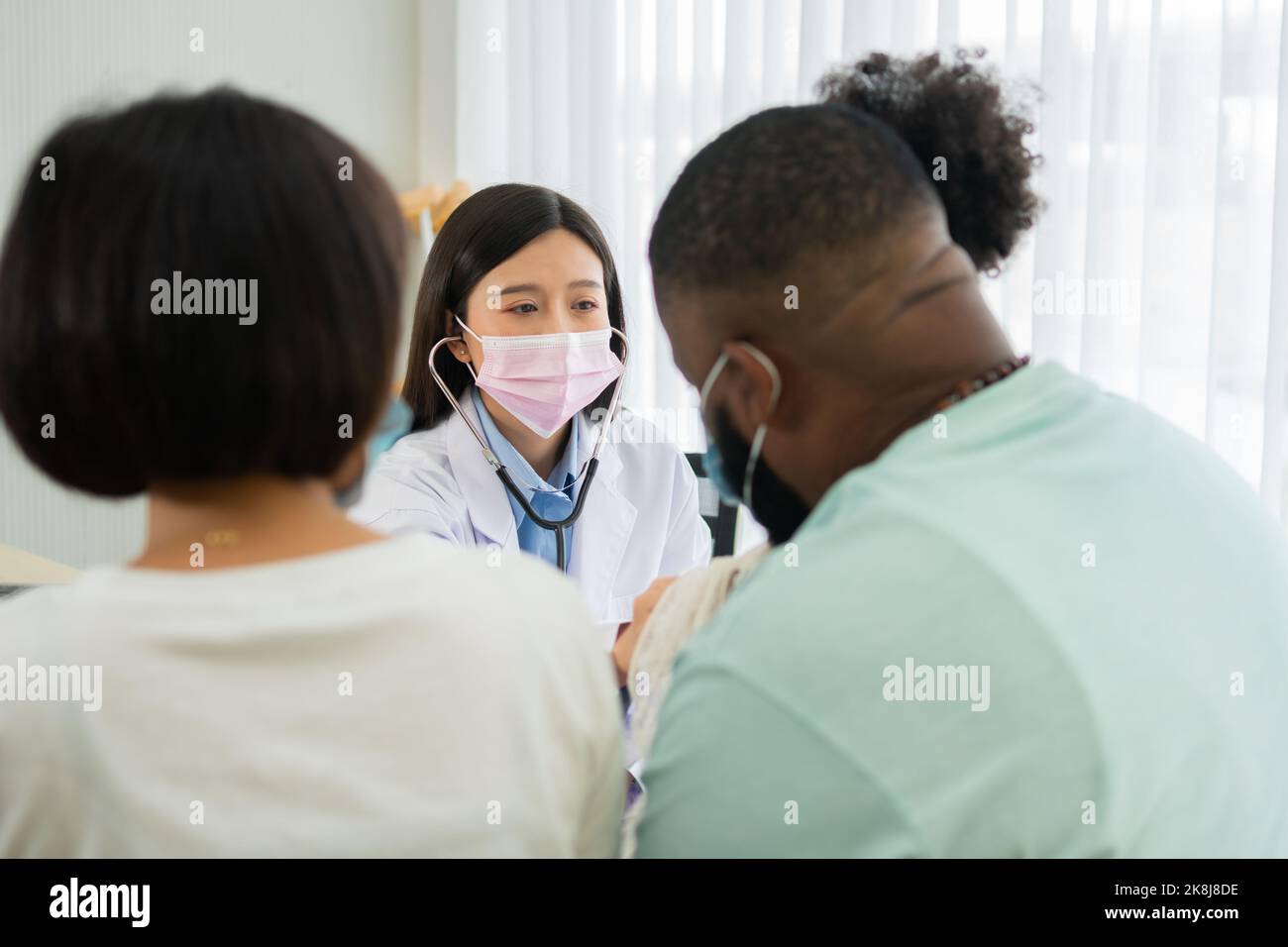Asian woman pediatrician doctor hold stethoscope for exam a little girl ...