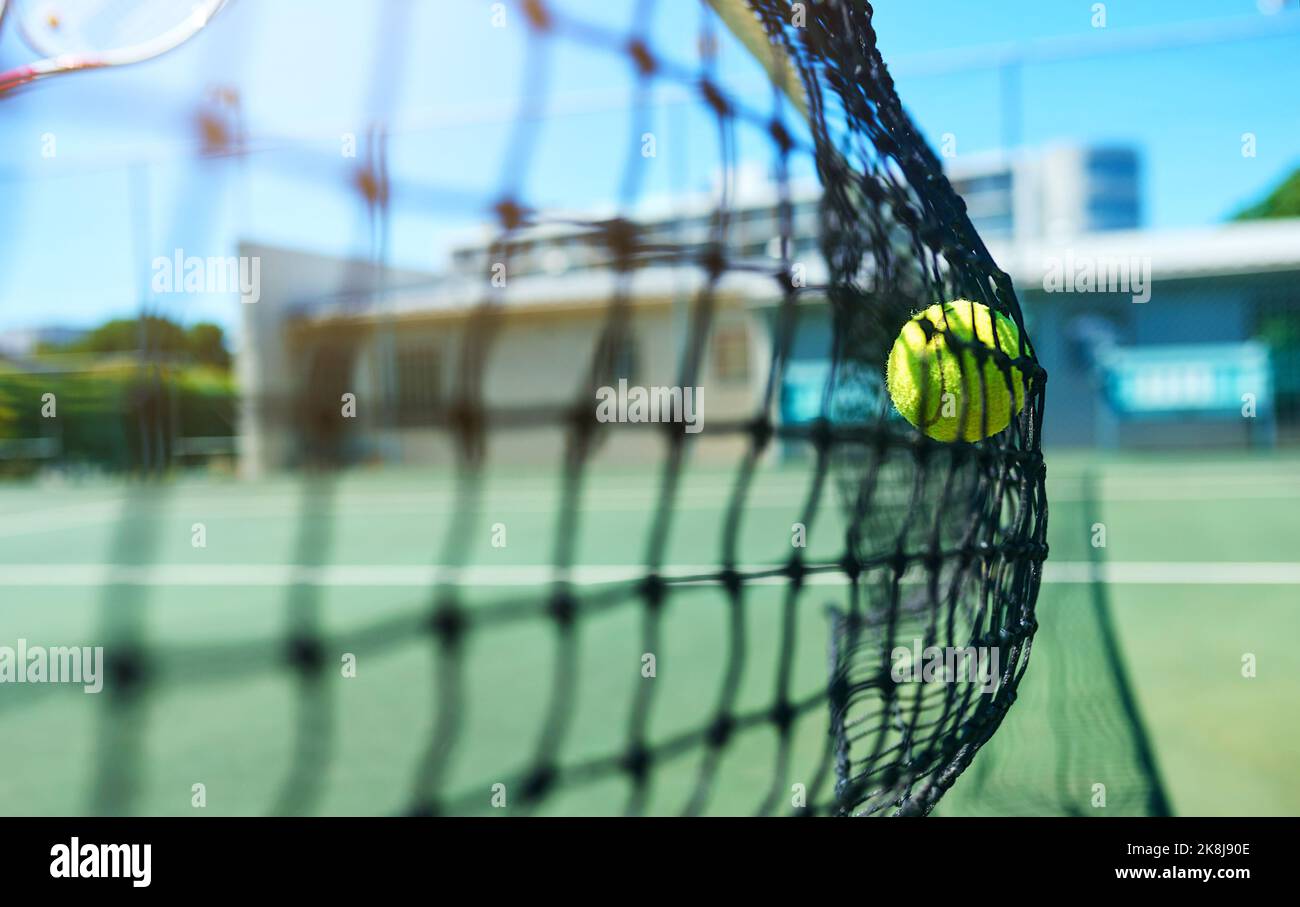 Zooming in for the action. a tennis ball hitting a tennis net on the ...