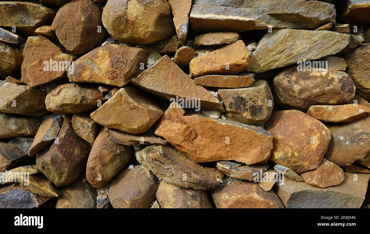 Beautiful background pattern image of a wall made of round stone red ...