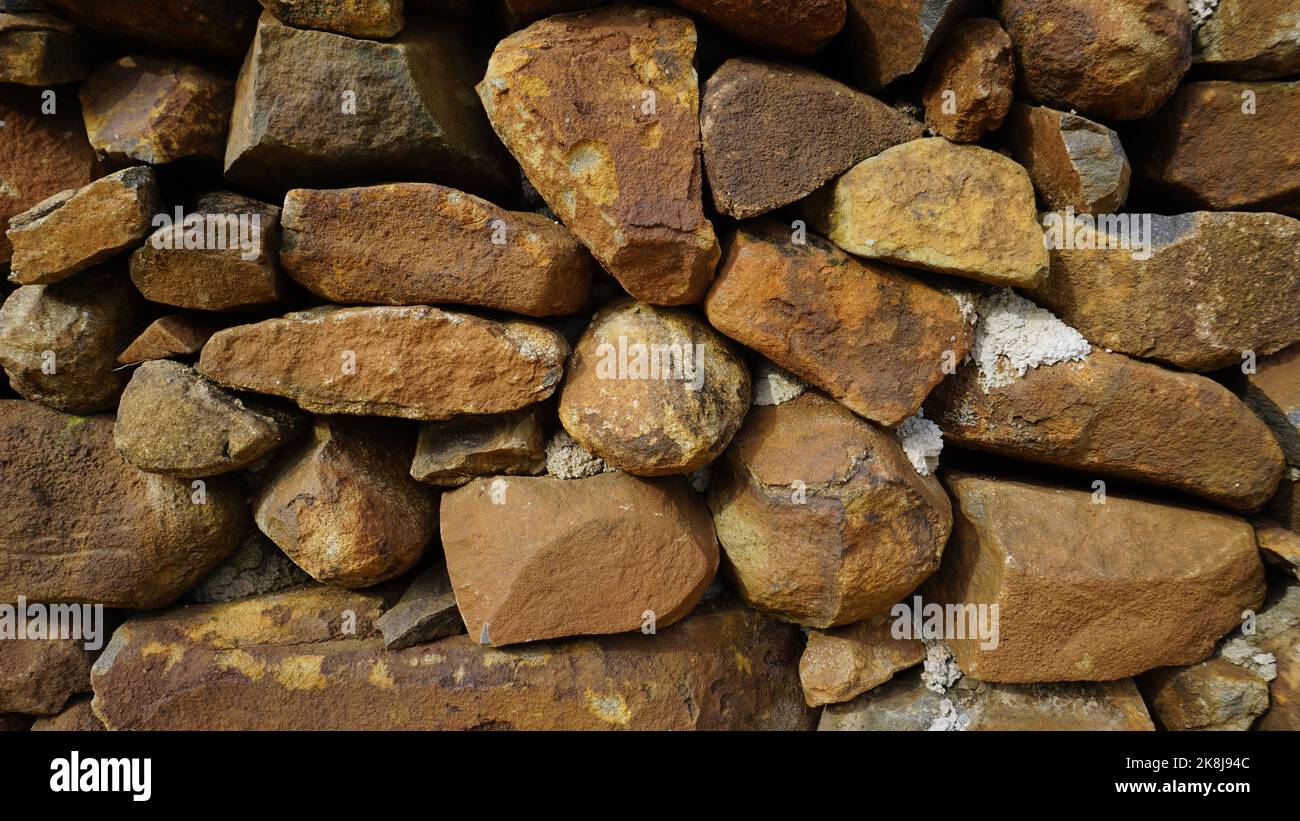 Beautiful background pattern image of a wall made of round stone red ...