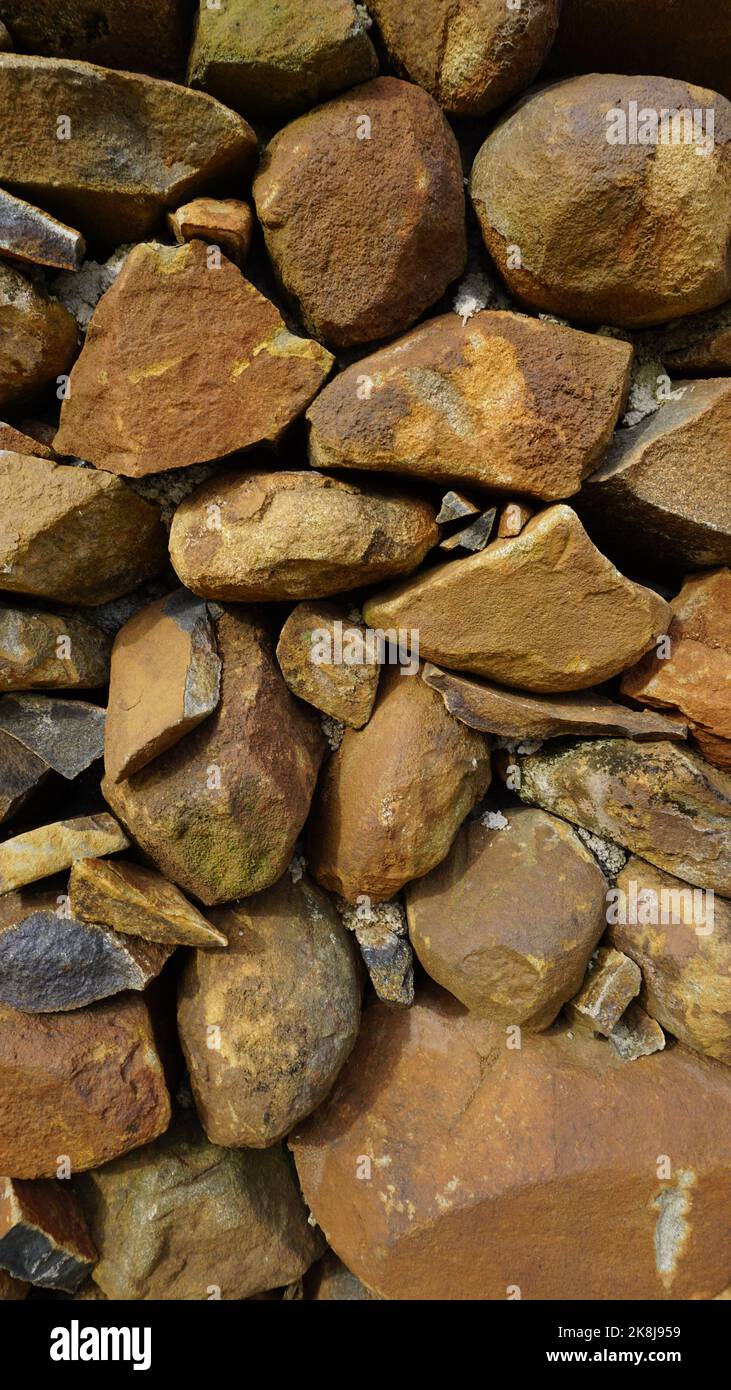 Beautiful background pattern image of a wall made of round stone red ...
