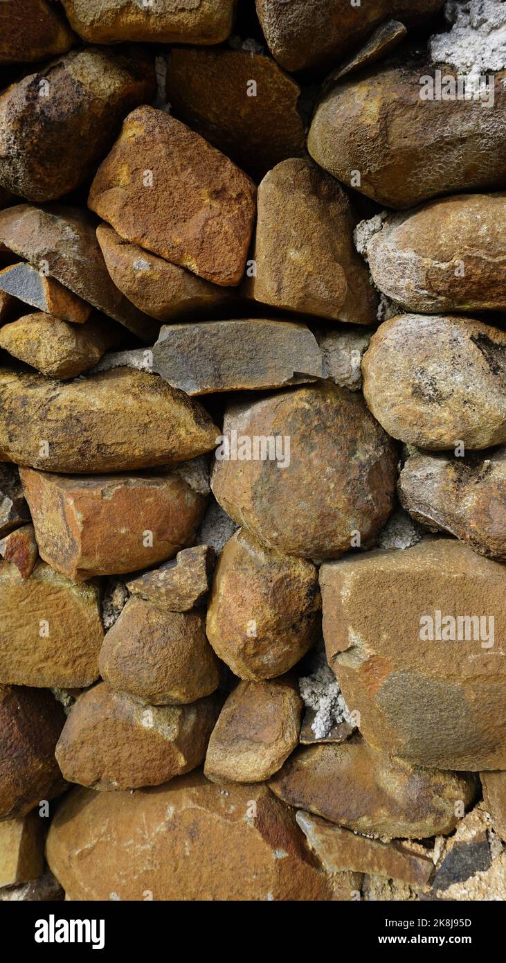 Beautiful background pattern image of a wall made of round stone red ...