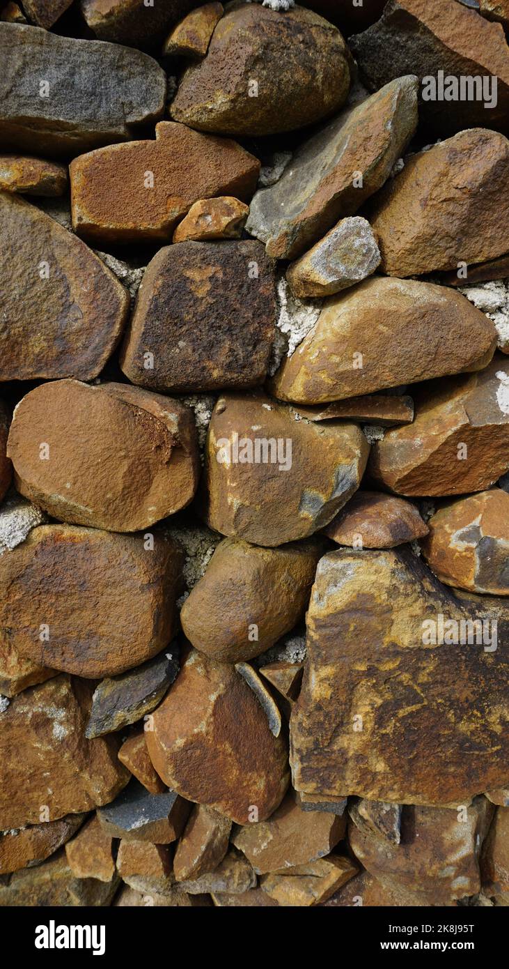 Beautiful background pattern image of a wall made of round stone red ...