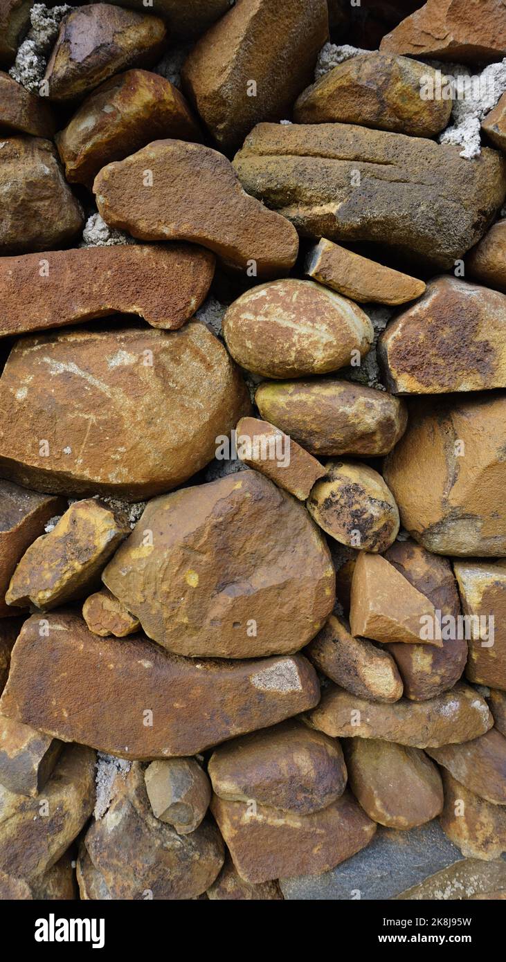 Beautiful background pattern image of a wall made of round stone red ...