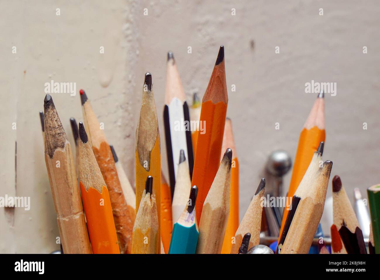 Different pencils in a jar on the table. Selective focus Stock Photo ...
