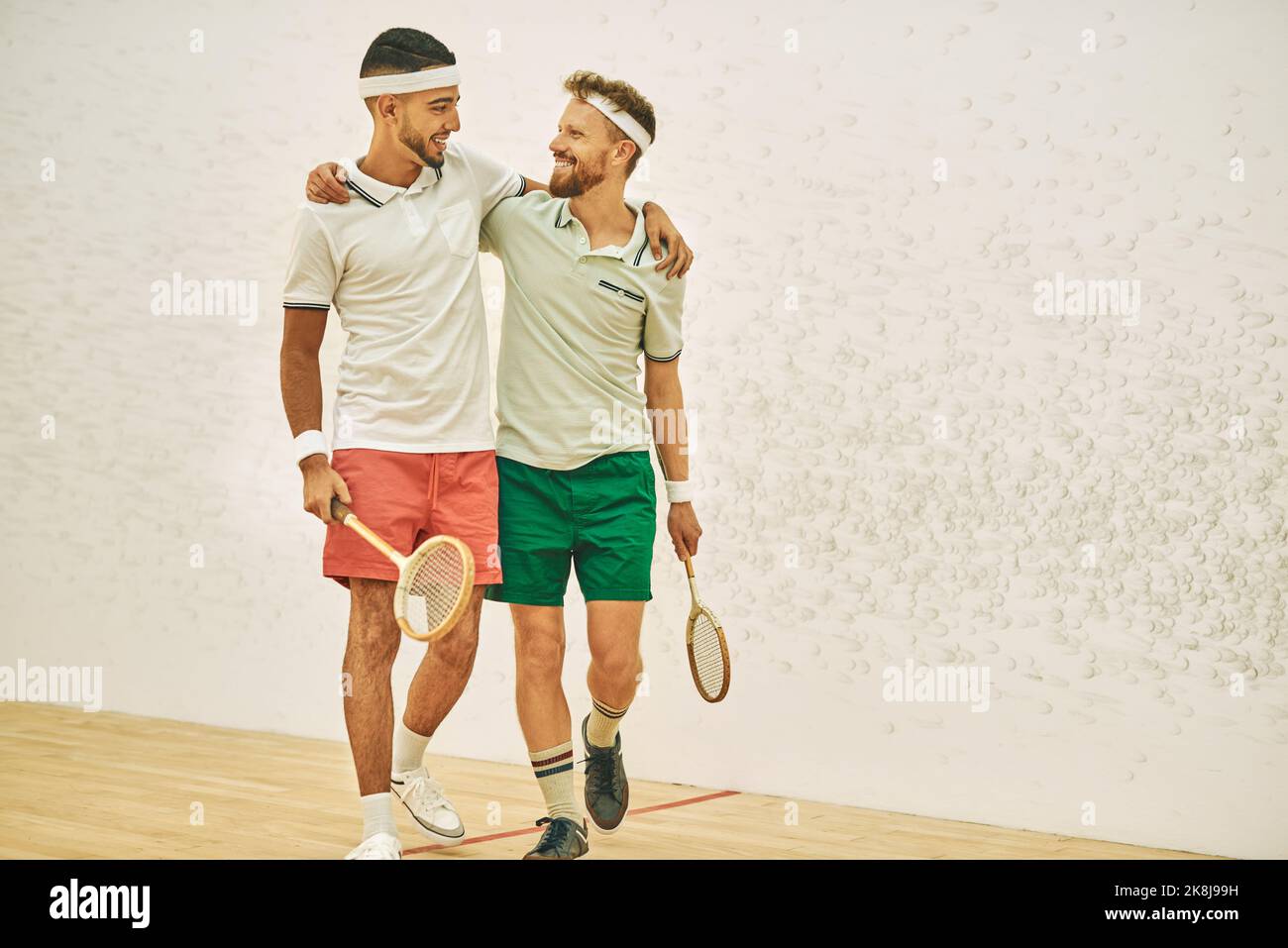 Squash players by nature, buddies by choice. two young men embracing at ...