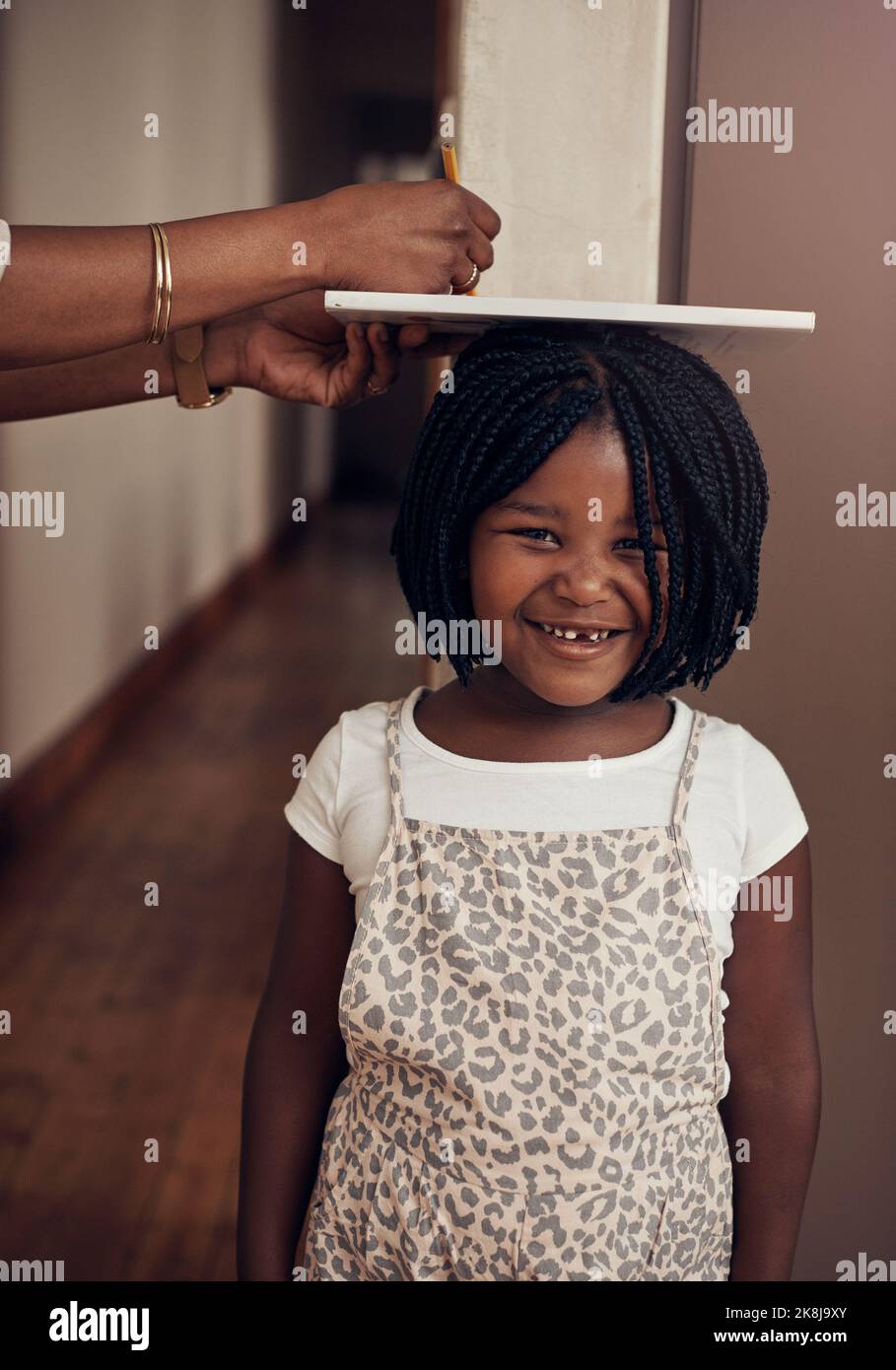 Shes getting bigger by the day. a mother measuring the height of her ...