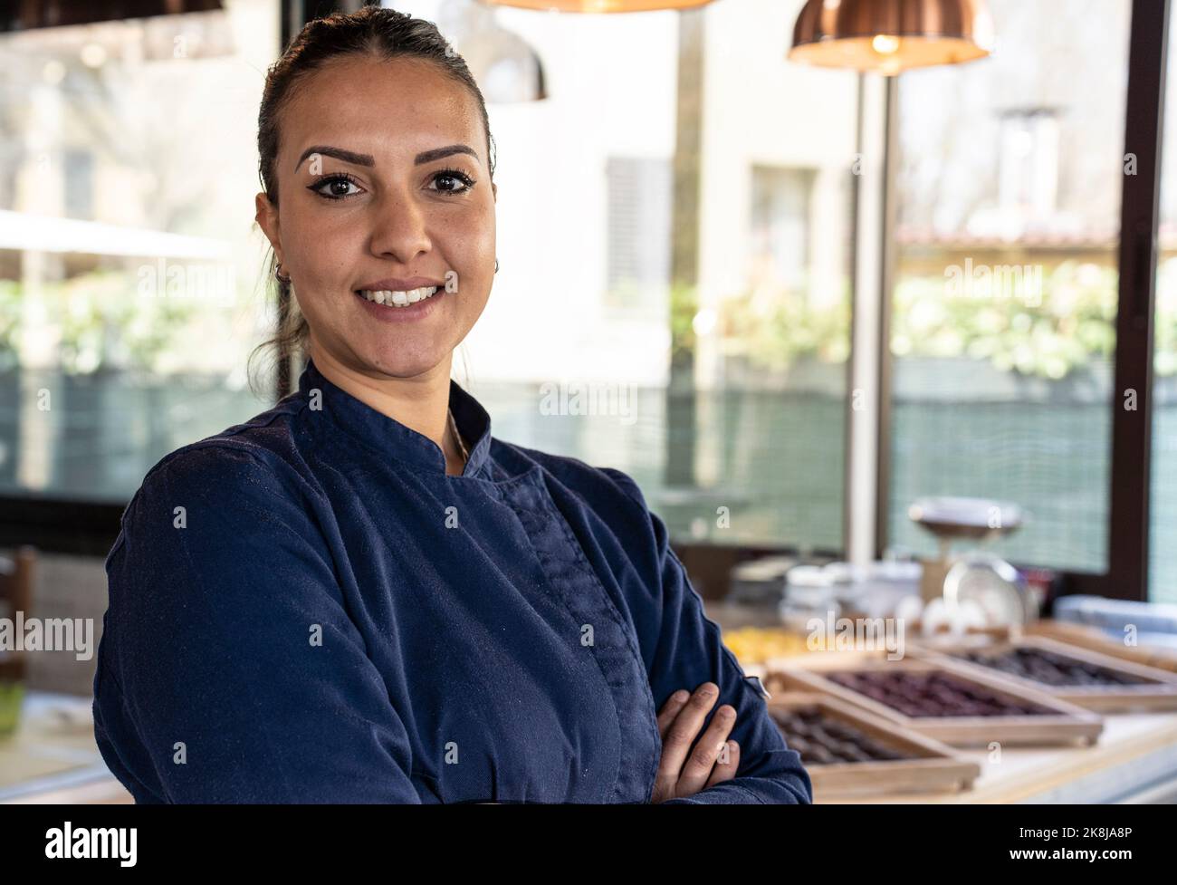 Young north african chef woman smiling on camera at the restaurant ...