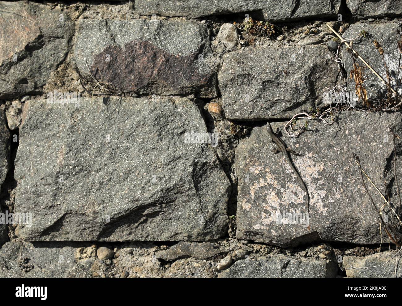 Stone wall with decorative stones and facings Stock Photo - Alamy