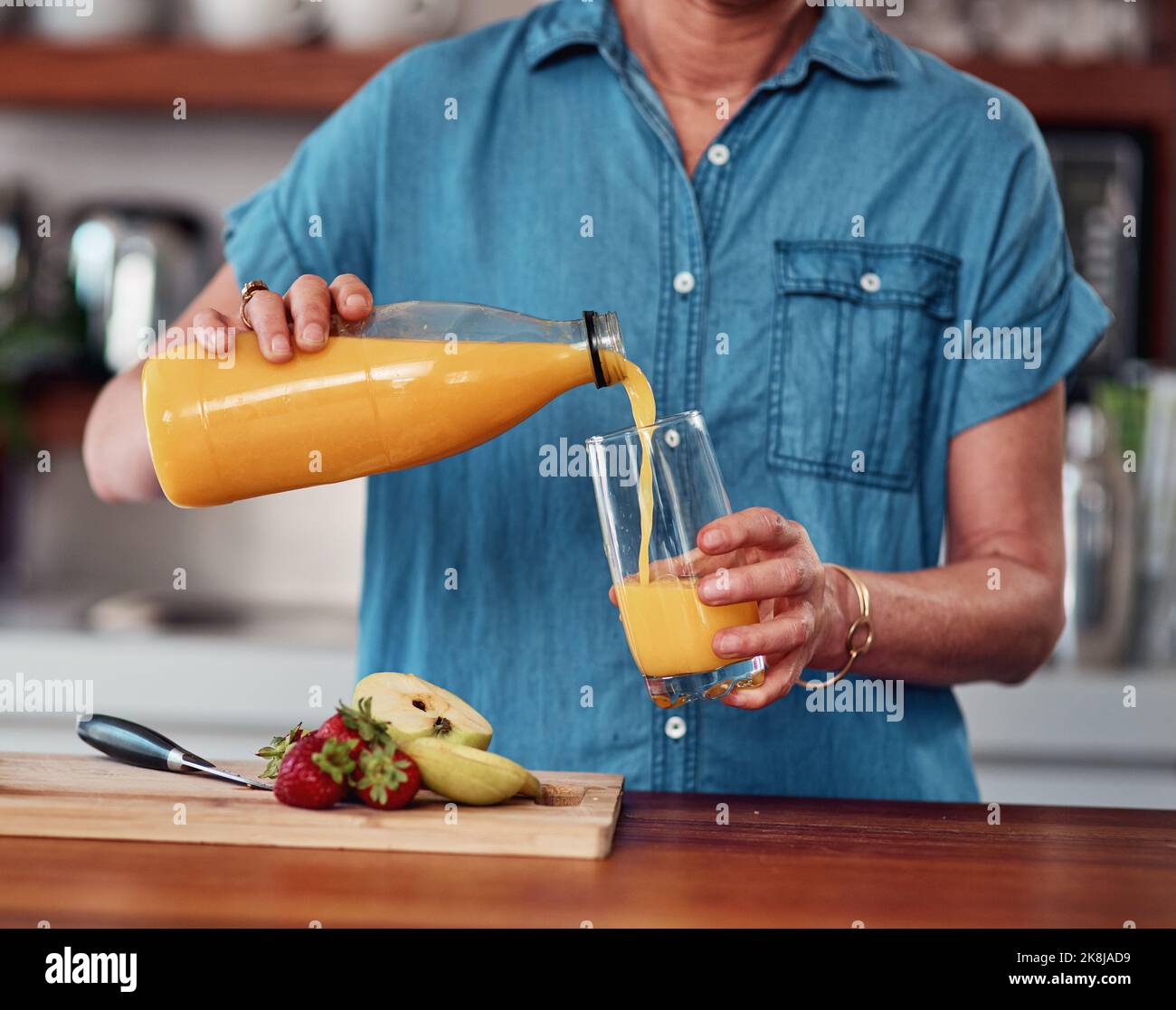 The best breakfast drink. an unrecognizable senior woman pouring ...