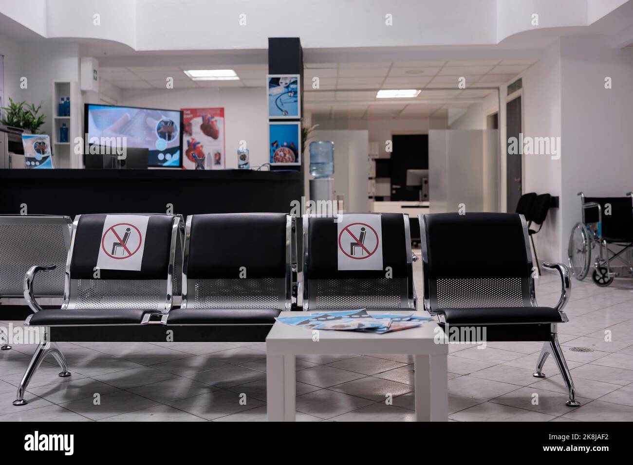 General shot of empty hospital waiting area. Sectioned seats to prevent ...