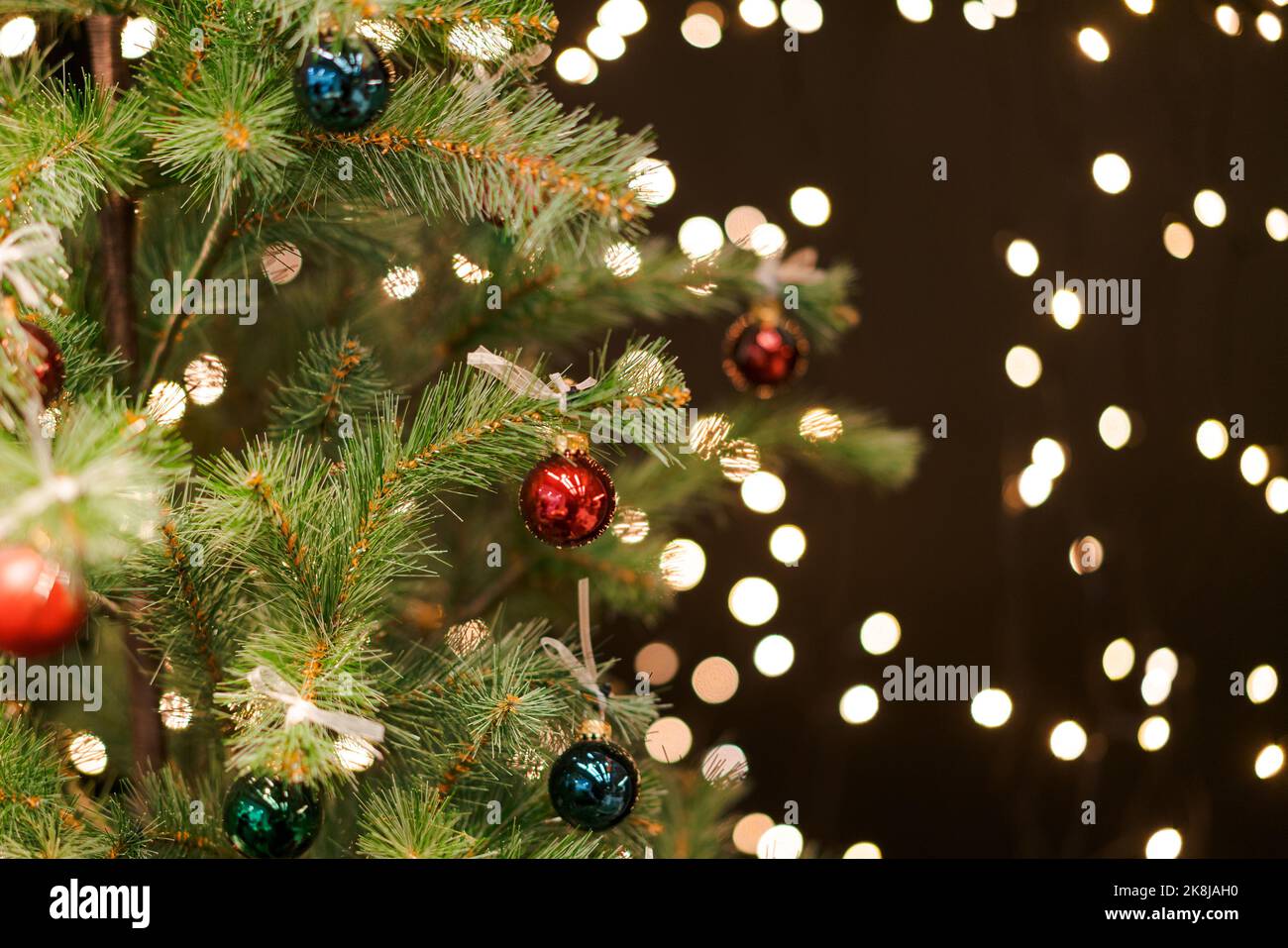 Close up balls on Christmas tree. Bokeh garlands in the background. New ...