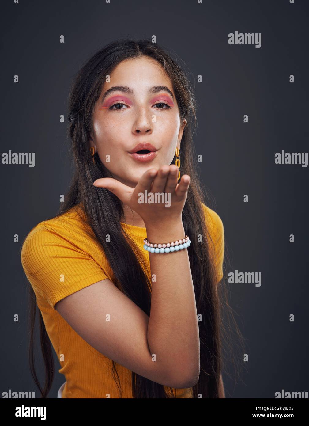 Blowing kisses. Cropped portrait of an attractive teenage girl standing ...