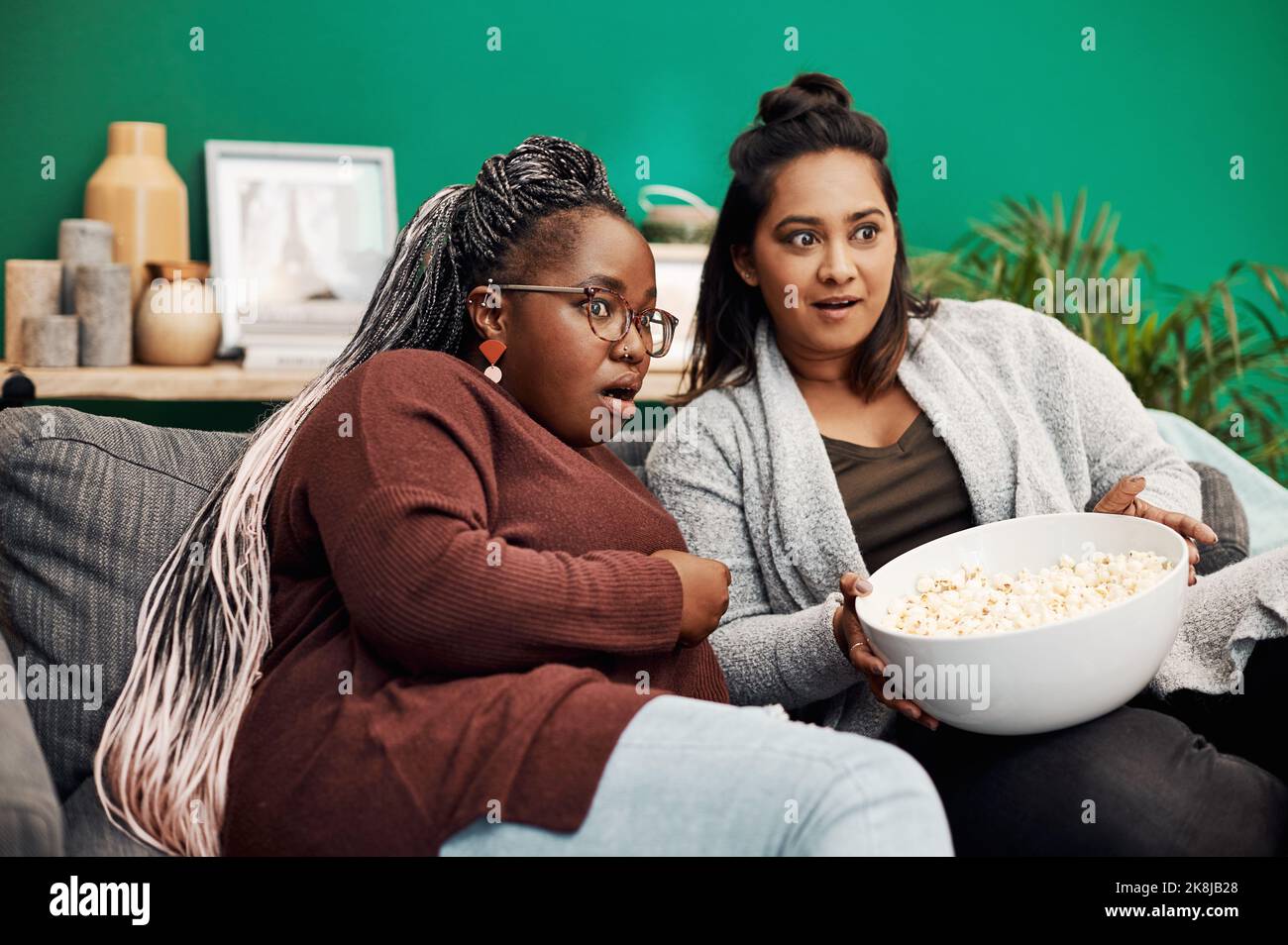 Movie marathons were made for girls night in. two young women having ...