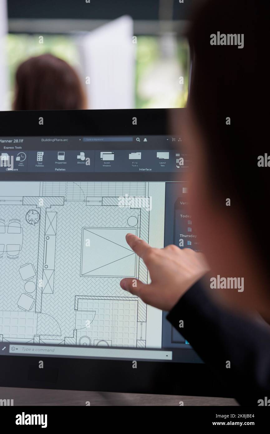 Real estate agent planning room floor in software, drafting, home ...