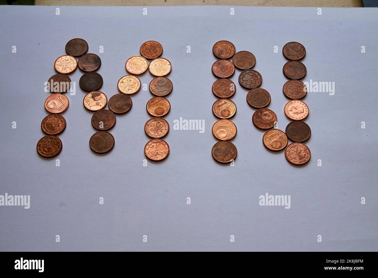 Letters m n of copper coins insulated on a white sheet of paper Stock ...