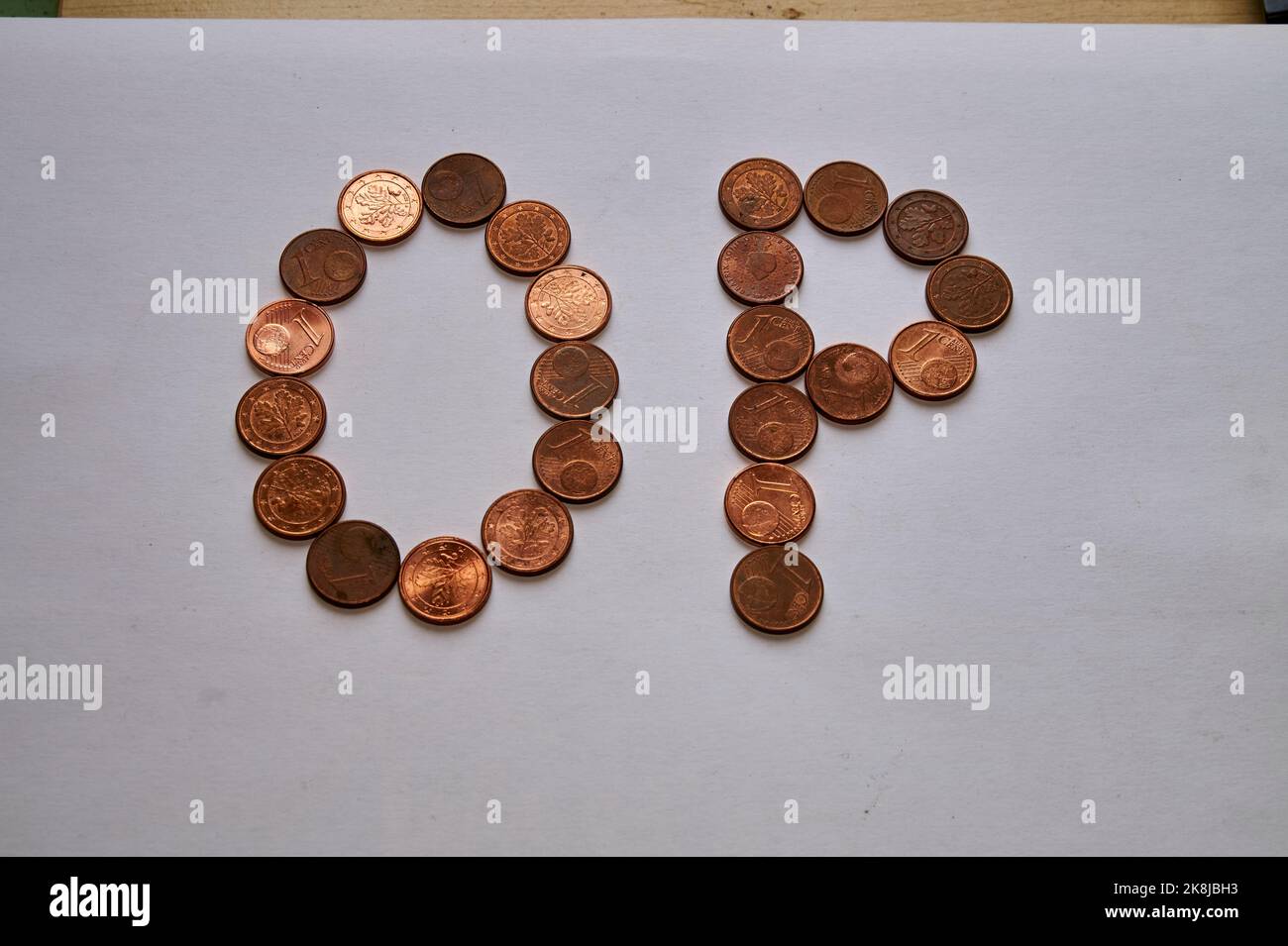 Letters o p of copper coins insulated on a white sheet of paper Stock ...