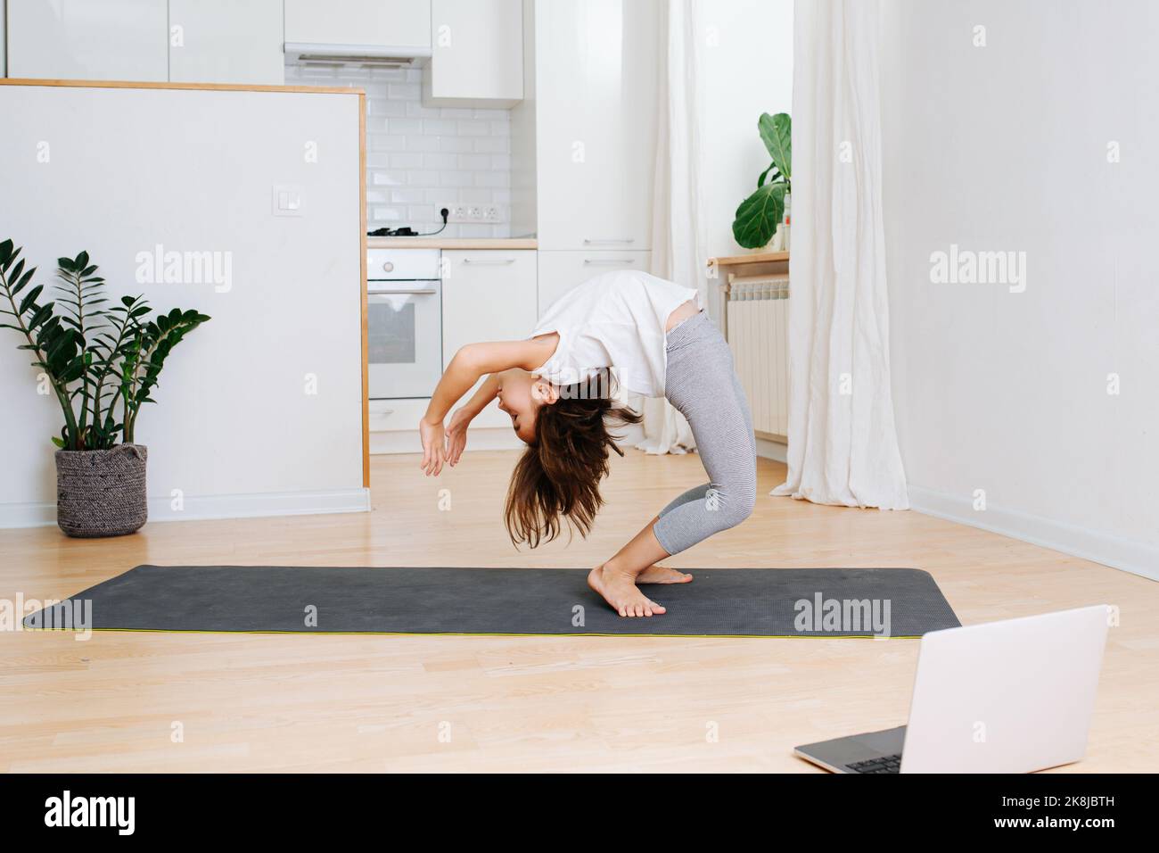 Dinamic image of a nine year old girl bending back in a brige exercise ...