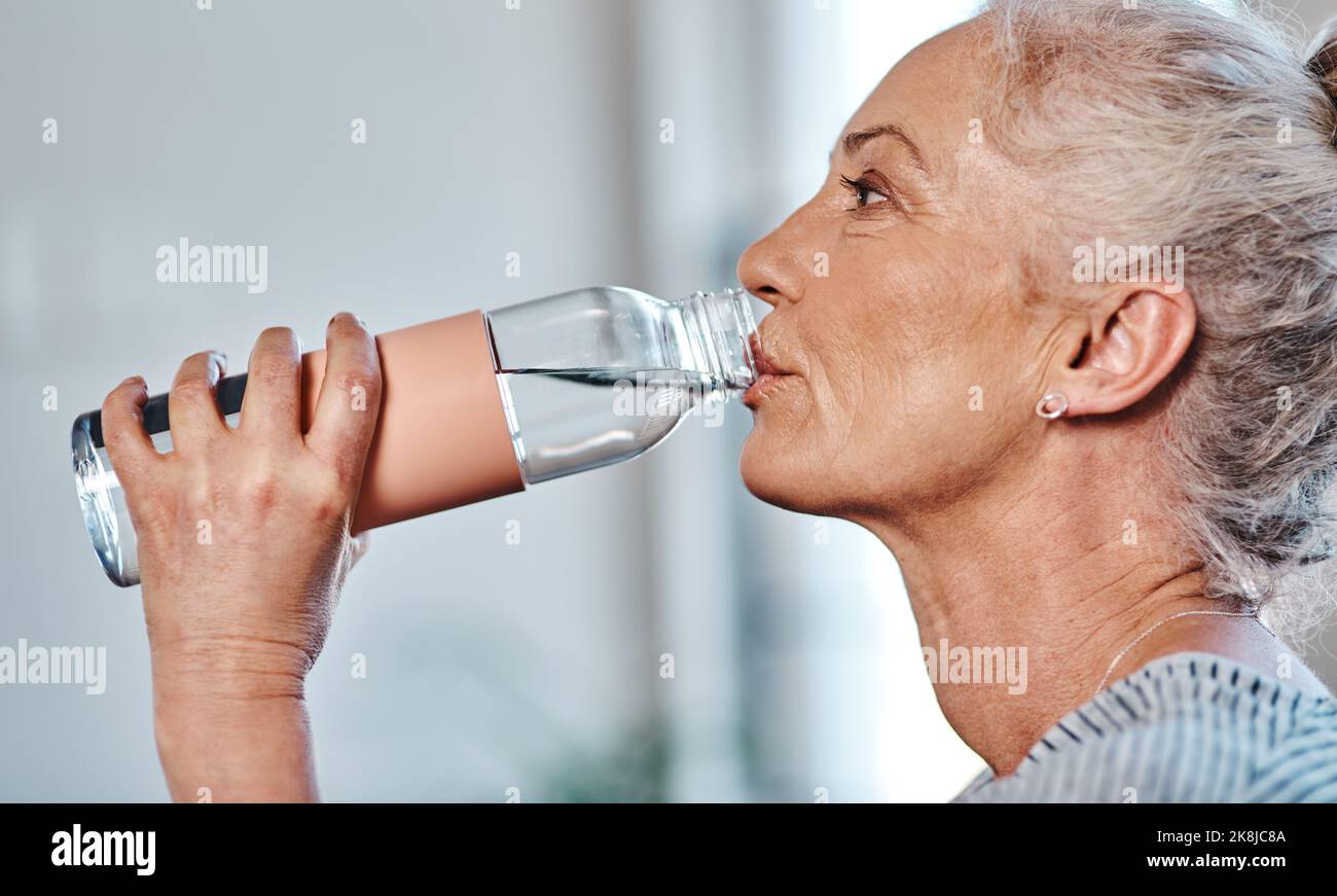 Water is your best friend. Closeup of a mature woman having a drink of ...