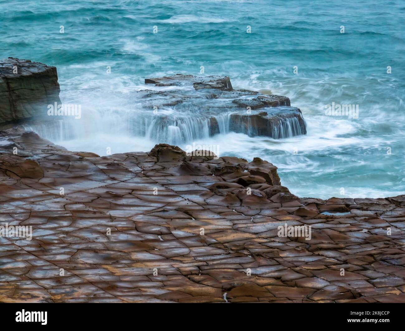 Aerial sunrise seascape over tessellated rock platform at North Avoca ...