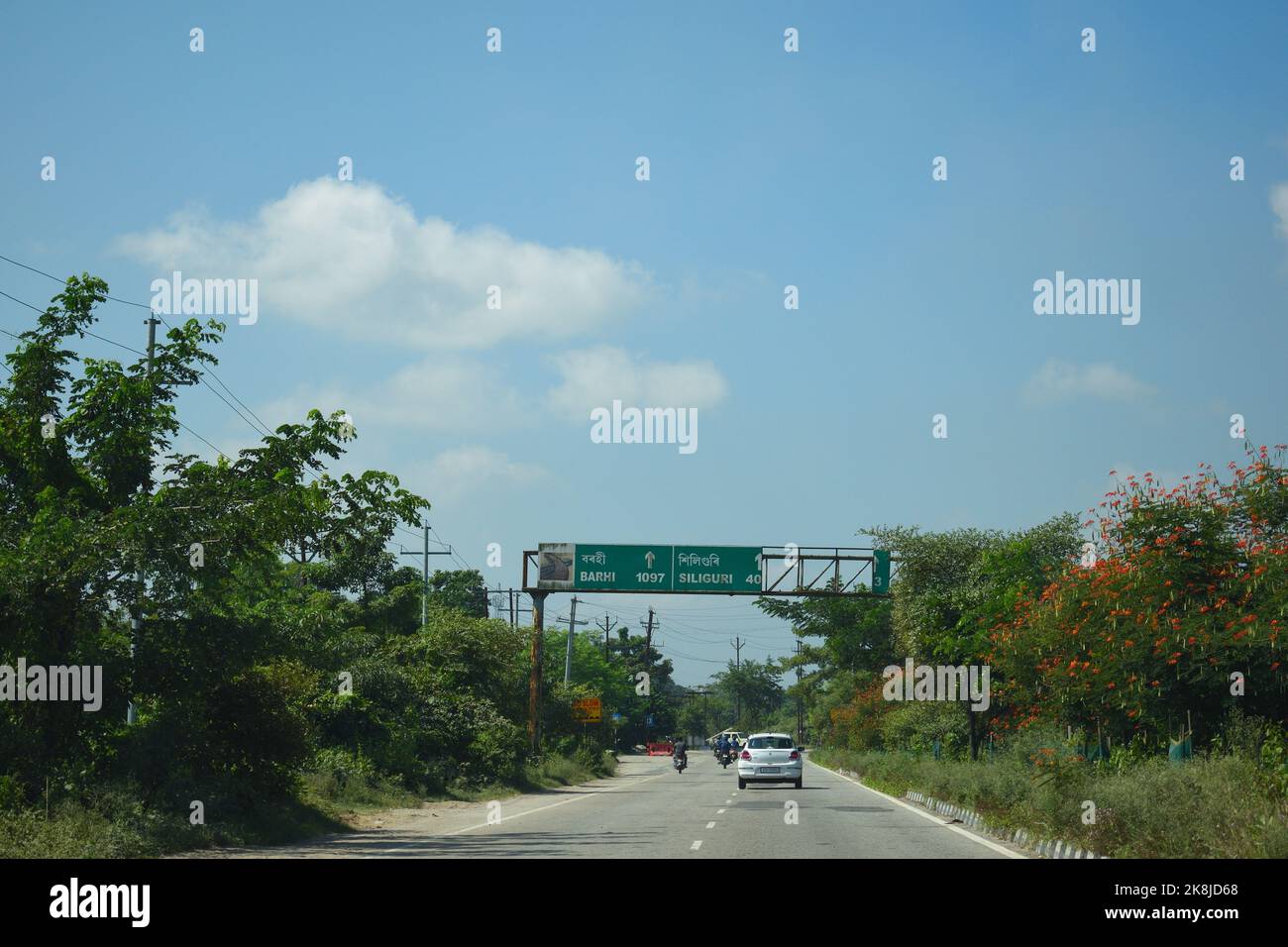 A Road Direction Board on National Highway 37 of Assam showing distance ...