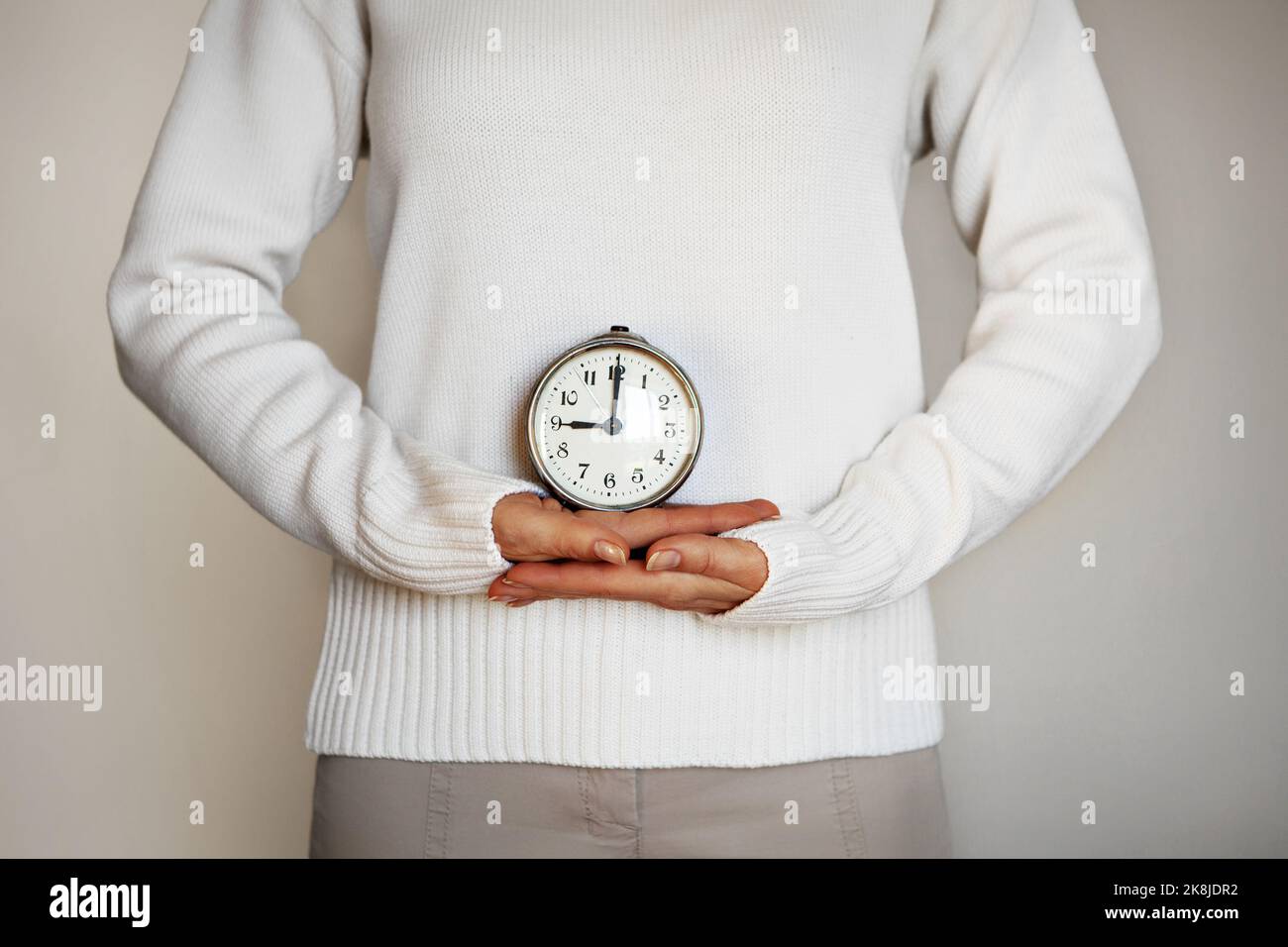 Hands holding alarm clock hi-res stock photography and images - Alamy