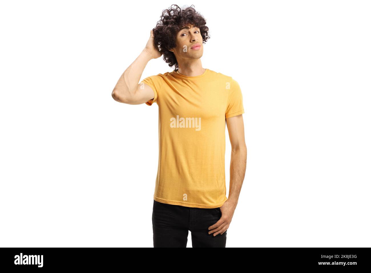 Pensive young man with curly hair thinking and holding head isolated on ...
