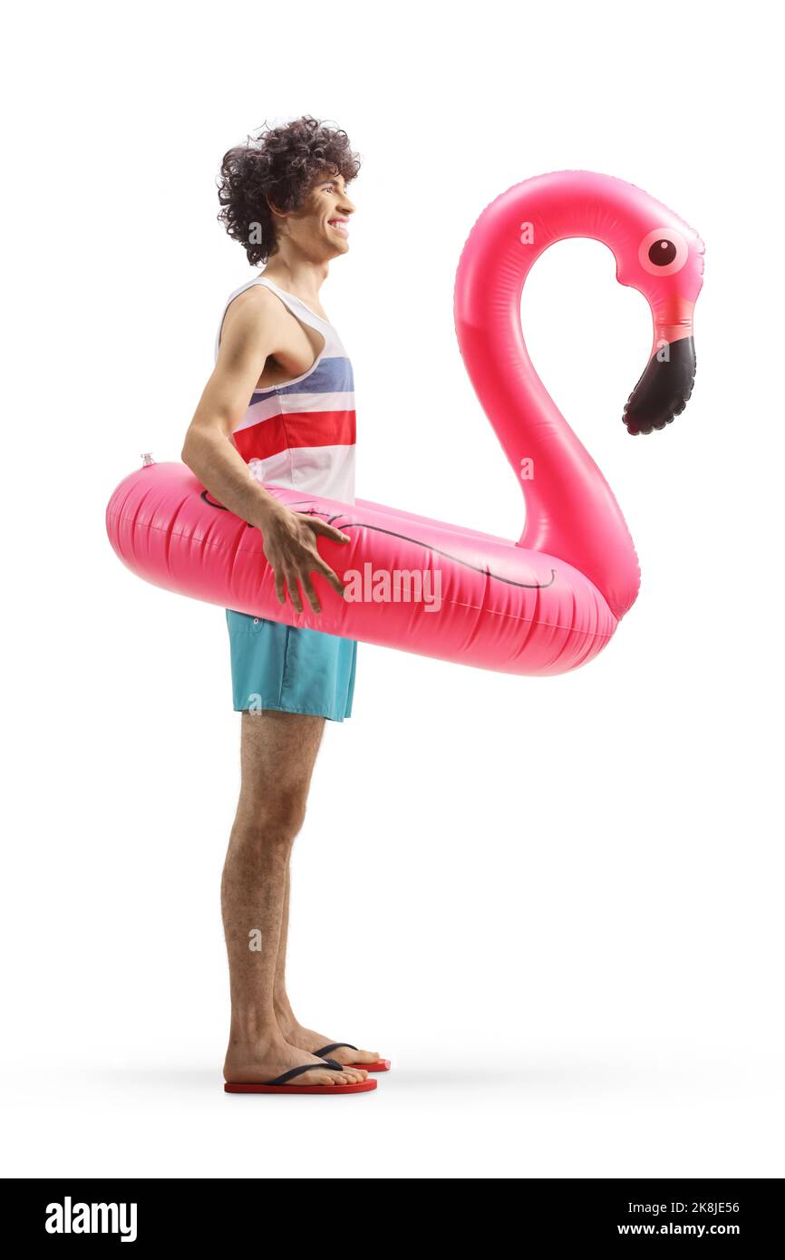 Ful length profile shot of a young man on summer vacation with flamingo ...