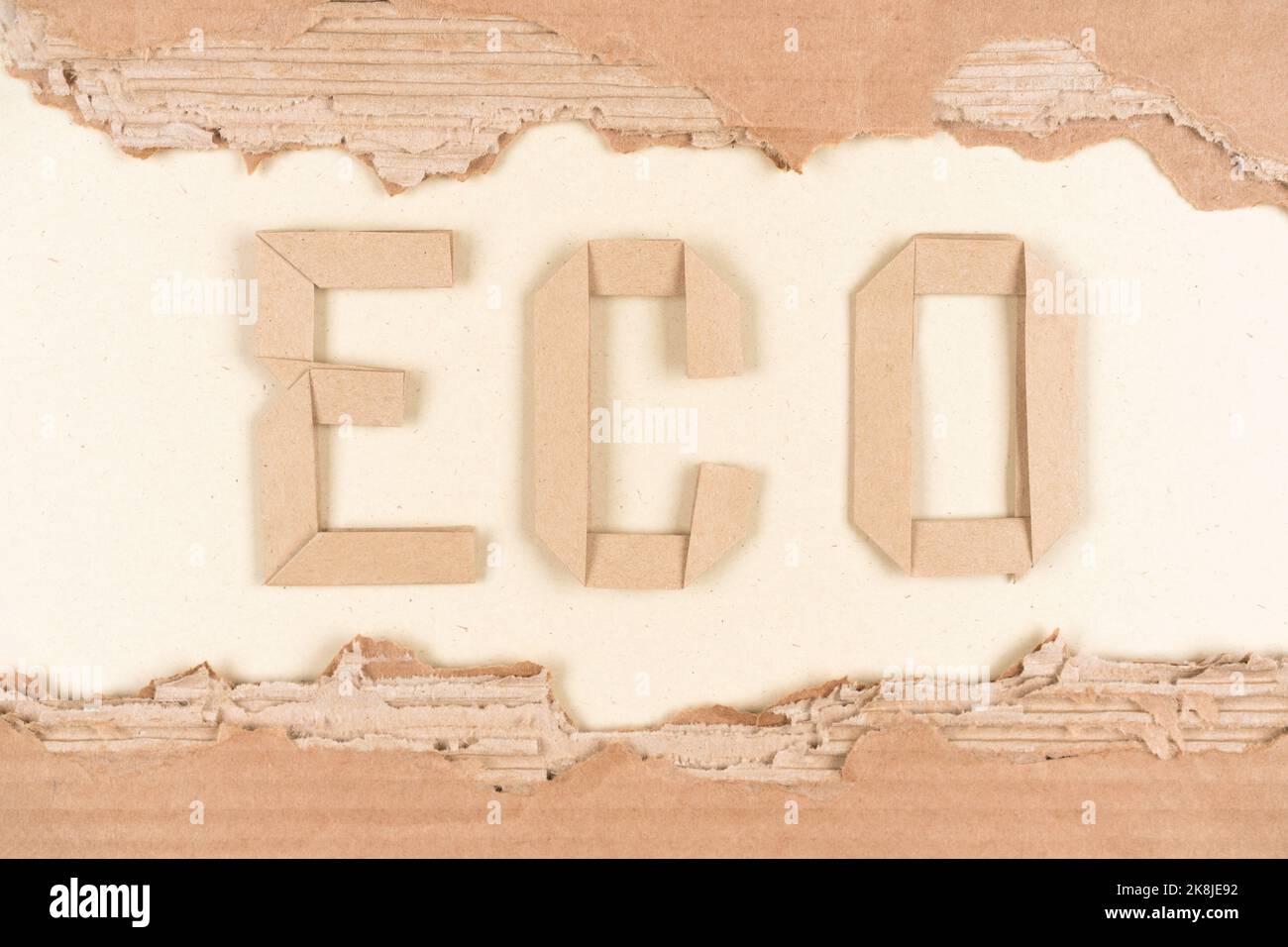 Text ECO made with paper letters and sheets of corrugated cardboard as ...