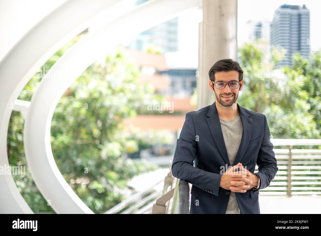 The Portrait of a happy young handsome Caucasian businessman with ...