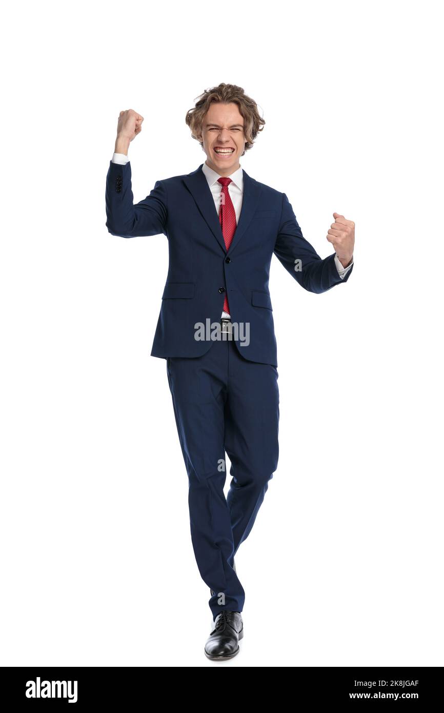 full body picture of excited businessman in suit with fists up ...
