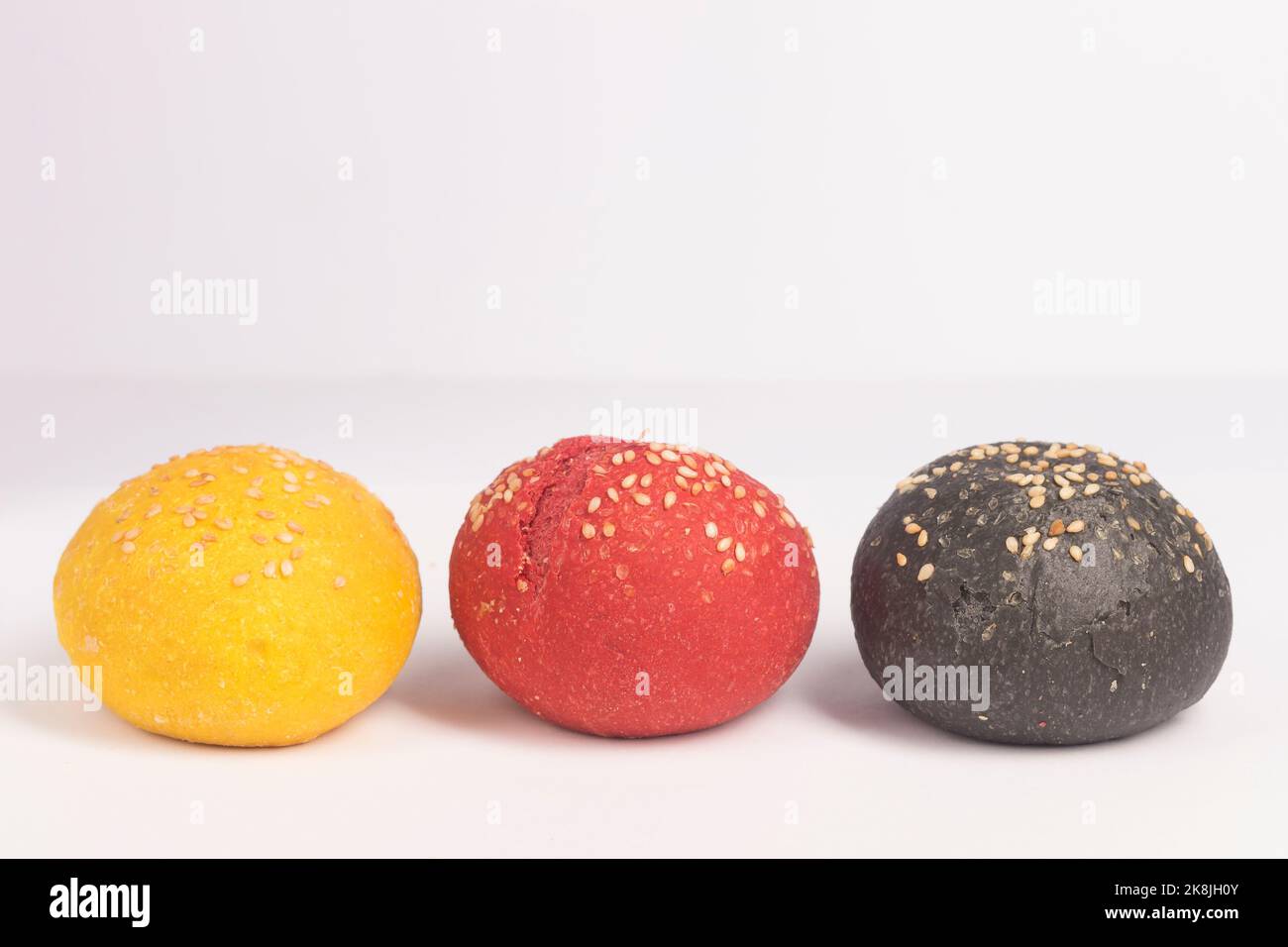 Colorful seasoned bread resting on a white background Stock Photo - Alamy