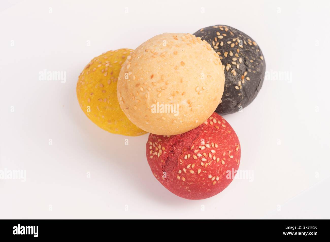 Colorful seasoned bread resting on a white background Stock Photo - Alamy