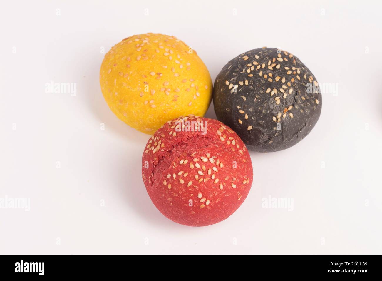 Colorful seasoned bread resting on a white background Stock Photo - Alamy