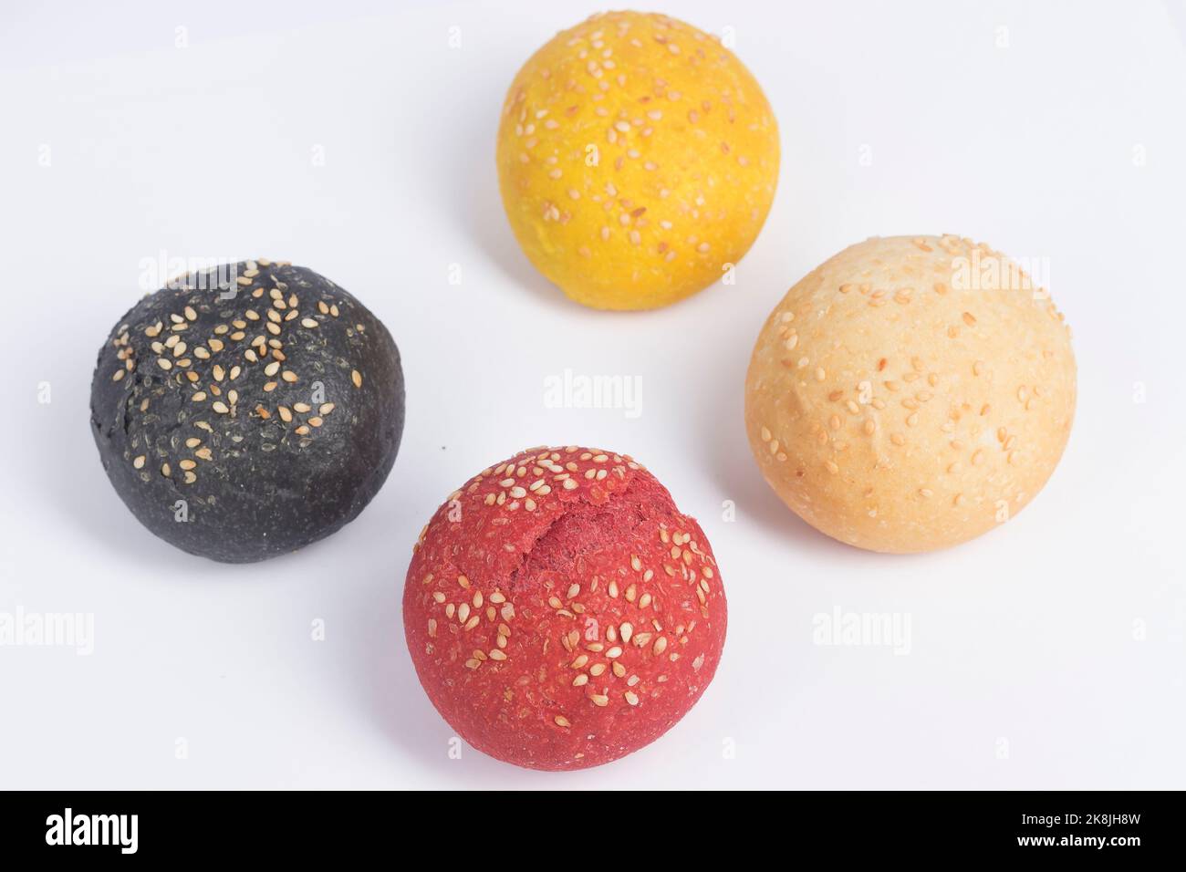 Colorful seasoned bread resting on a white background Stock Photo - Alamy