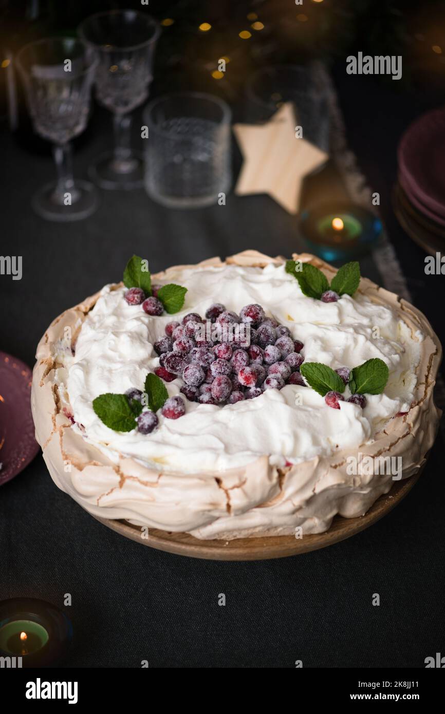 Christmas cake Pavlova with cranberries decorated with on dark blue ...