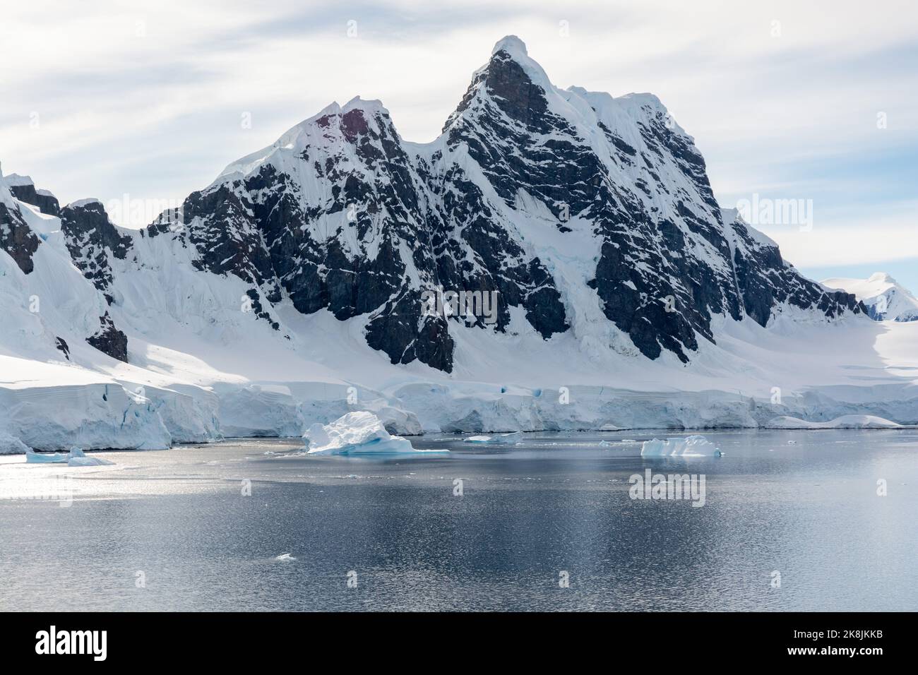 snow covered peaks on lemaire island. northern side of bryde channel ...