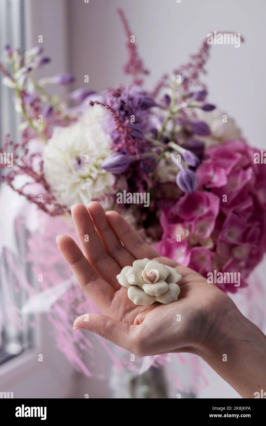 Hands holding beautiful decorative rose. floral concept Stock Photo - Alamy